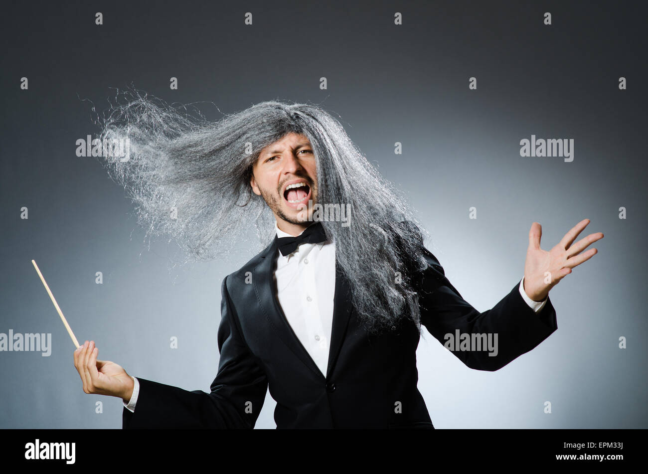 Funny conductor with long grey hair Stock Photo - Alamy