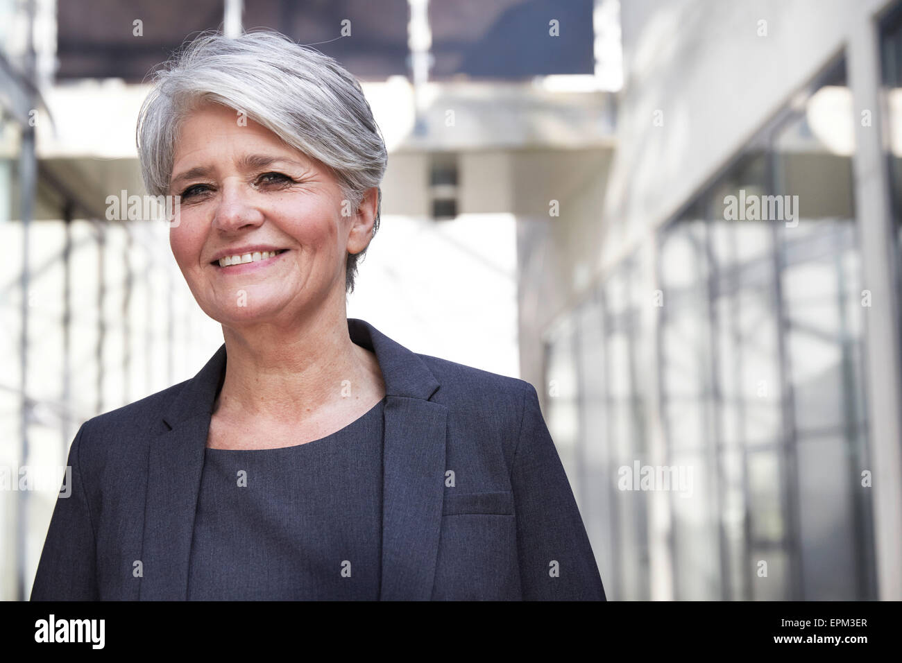 Portrait of smiling career woman in a modern building Stock Photo - Alamy