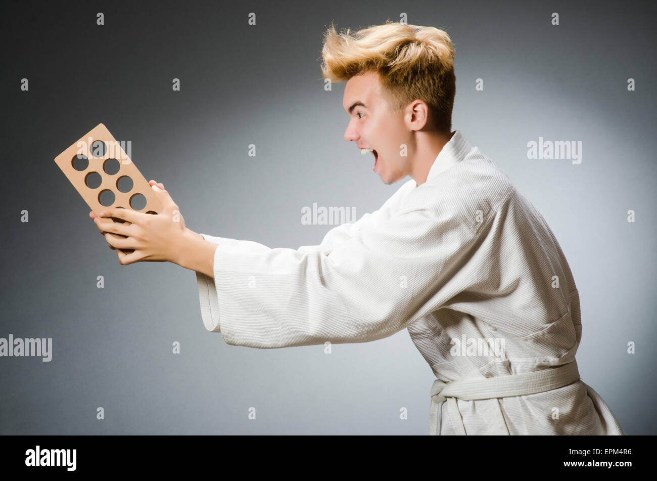 Funny karate fighter with clay brick Stock Photo - Alamy