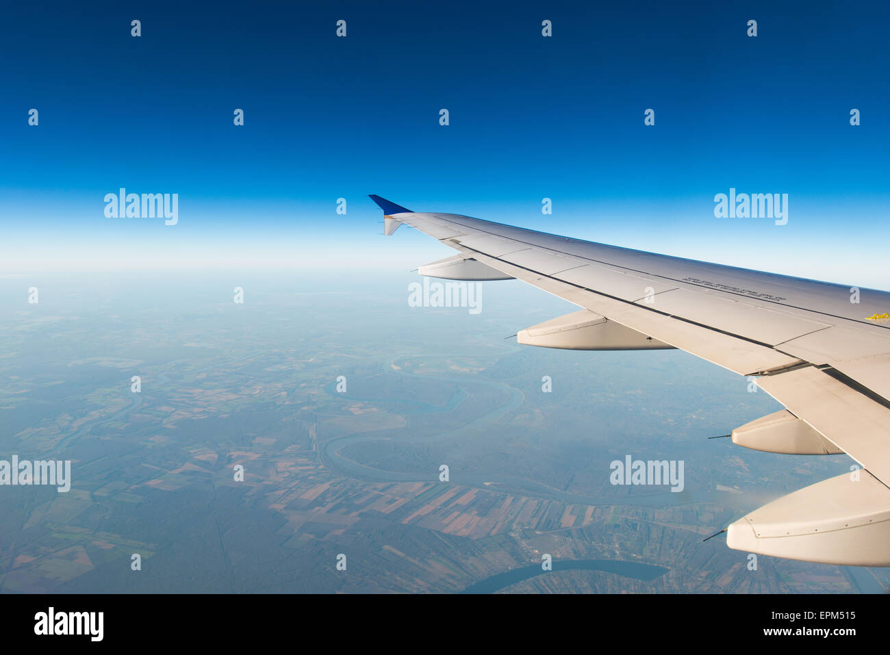 Airplane wing out of window Stock Photo - Alamy