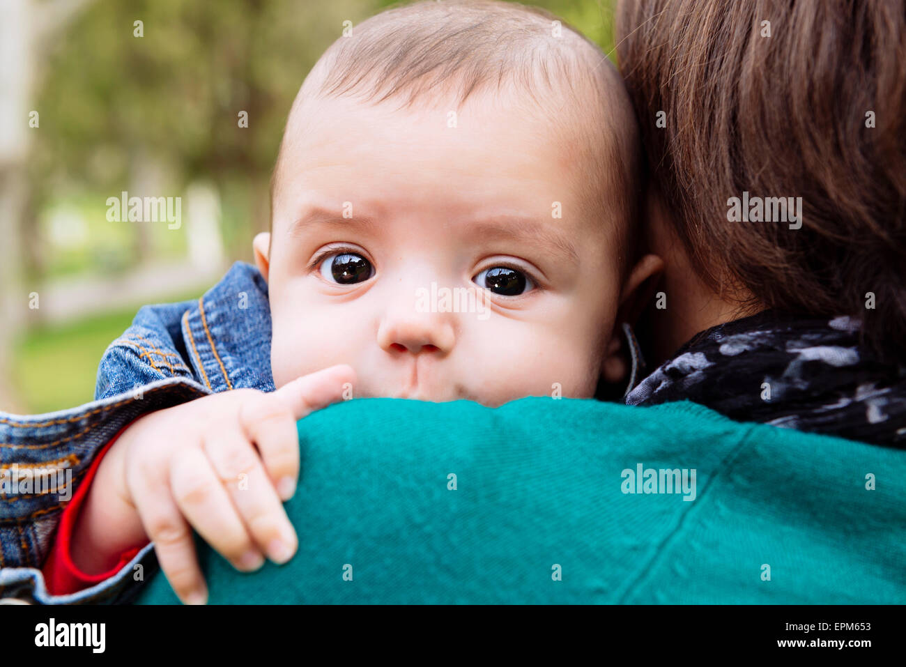 Mother carrying child over shoulder hi-res stock photography and images ...