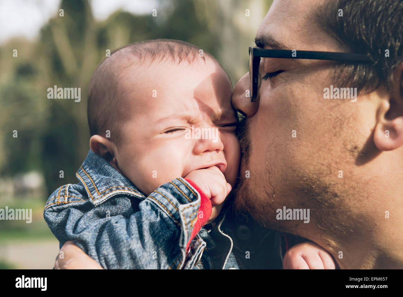 Father kissing his crying baby Stock Photo - Alamy