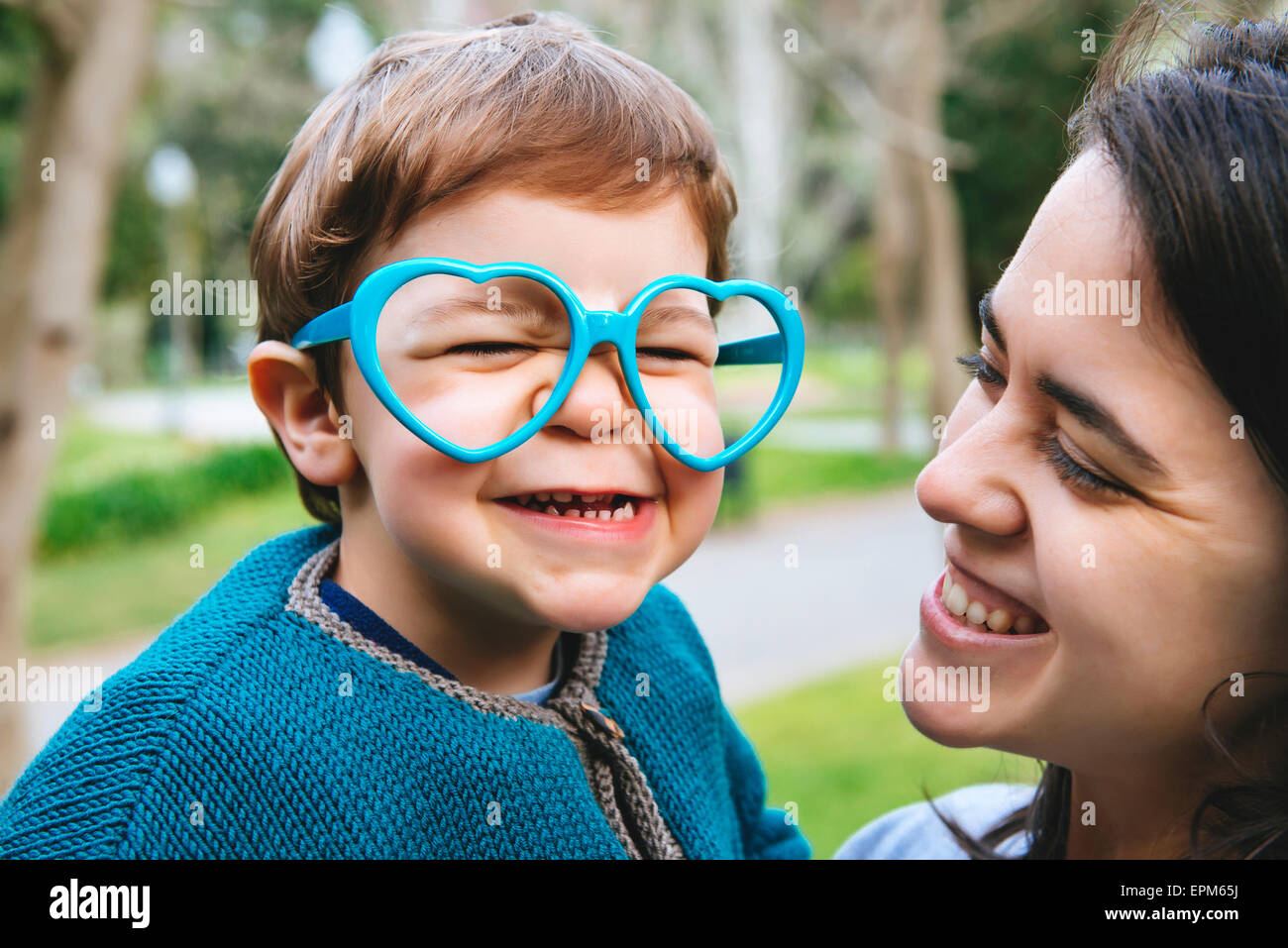 Portrait of little boy making faces with heart shaped glasses Stock ...