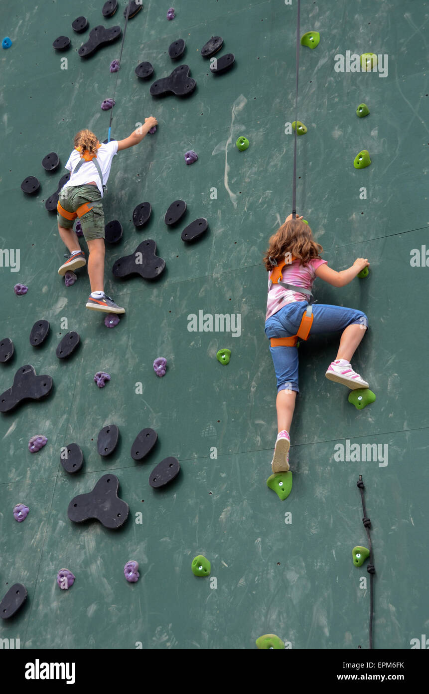 Young girls having an adventure climbing and jumping at a fun park ...