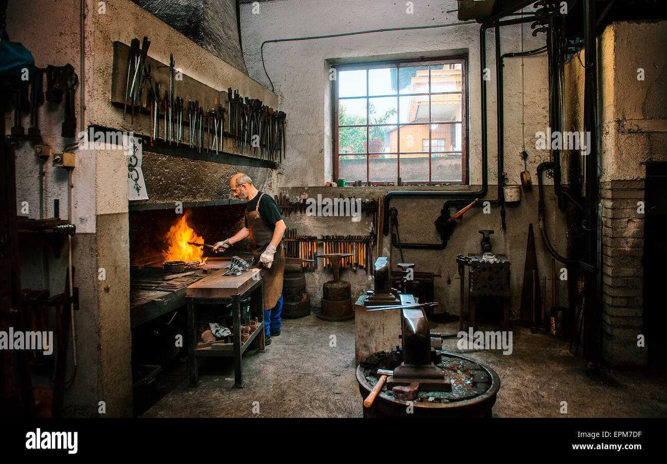 Senior blacksmith working in hammer mill Stock Photo - Alamy