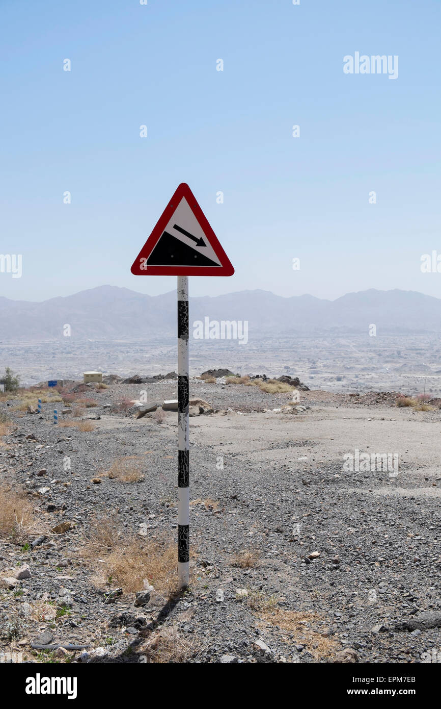 Oman, Warning sign for downward slope Stock Photo - Alamy
