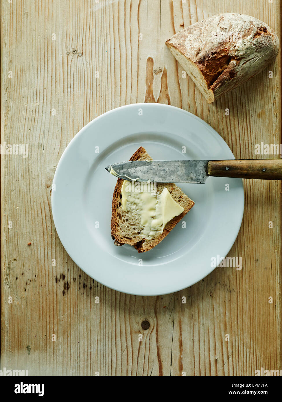Plate with bread and butter Stock Photo - Alamy