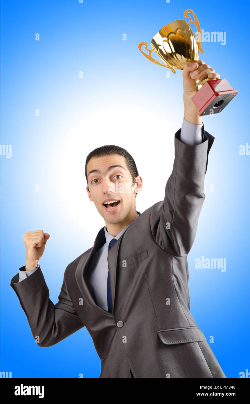 Man being awarded with golden cup Stock Photo - Alamy