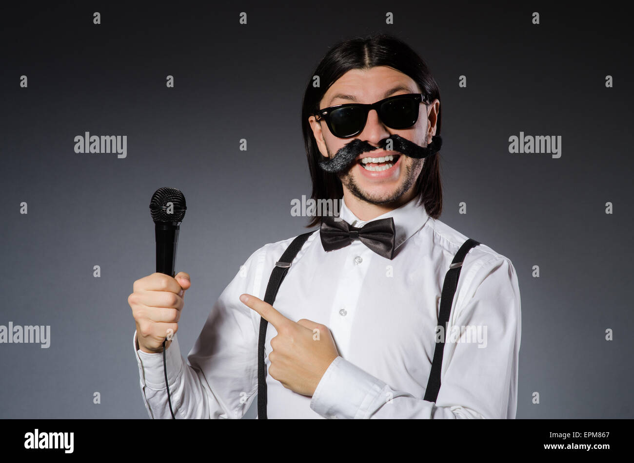 Funny singer with microphone at the concert Stock Photo - Alamy