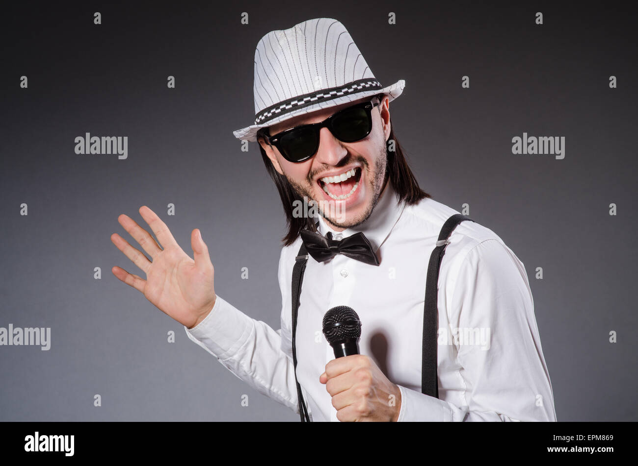 Funny singer with microphone at the concert Stock Photo - Alamy