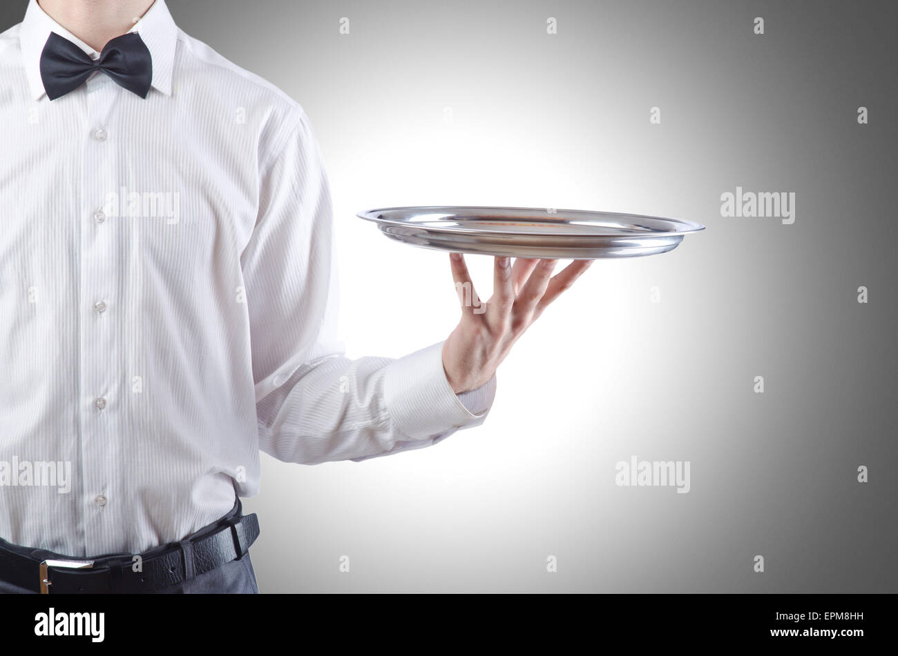 Young waiter with silver tray Stock Photo - Alamy