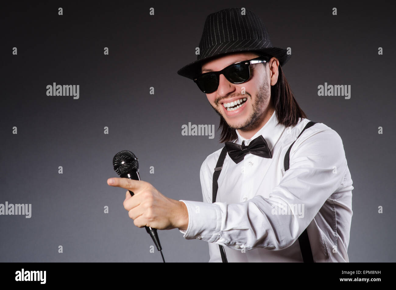 Funny singer with microphone at the concert Stock Photo - Alamy