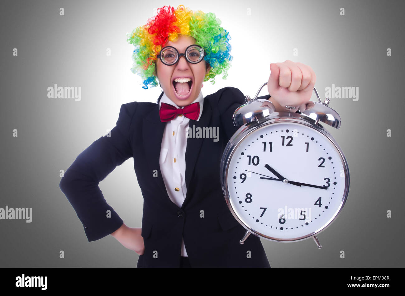 Funny clown with clock on white Stock Photo - Alamy