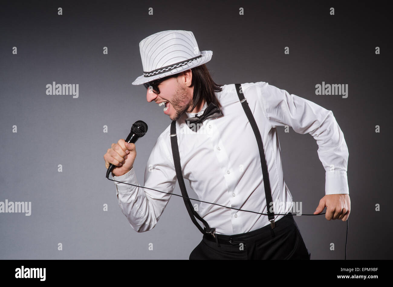 Funny singer with microphone at the concert Stock Photo - Alamy