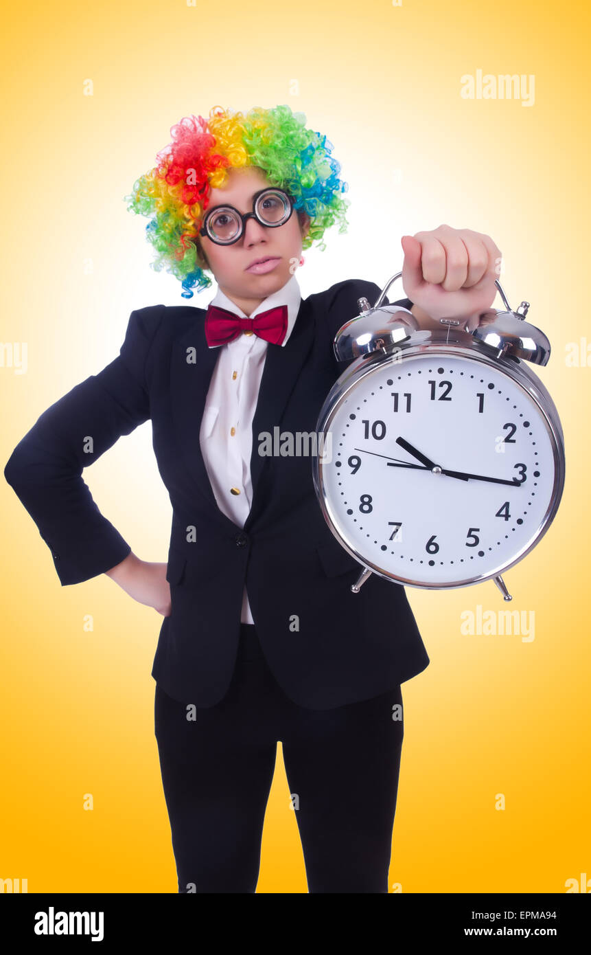 Funny clown with clock on white Stock Photo - Alamy