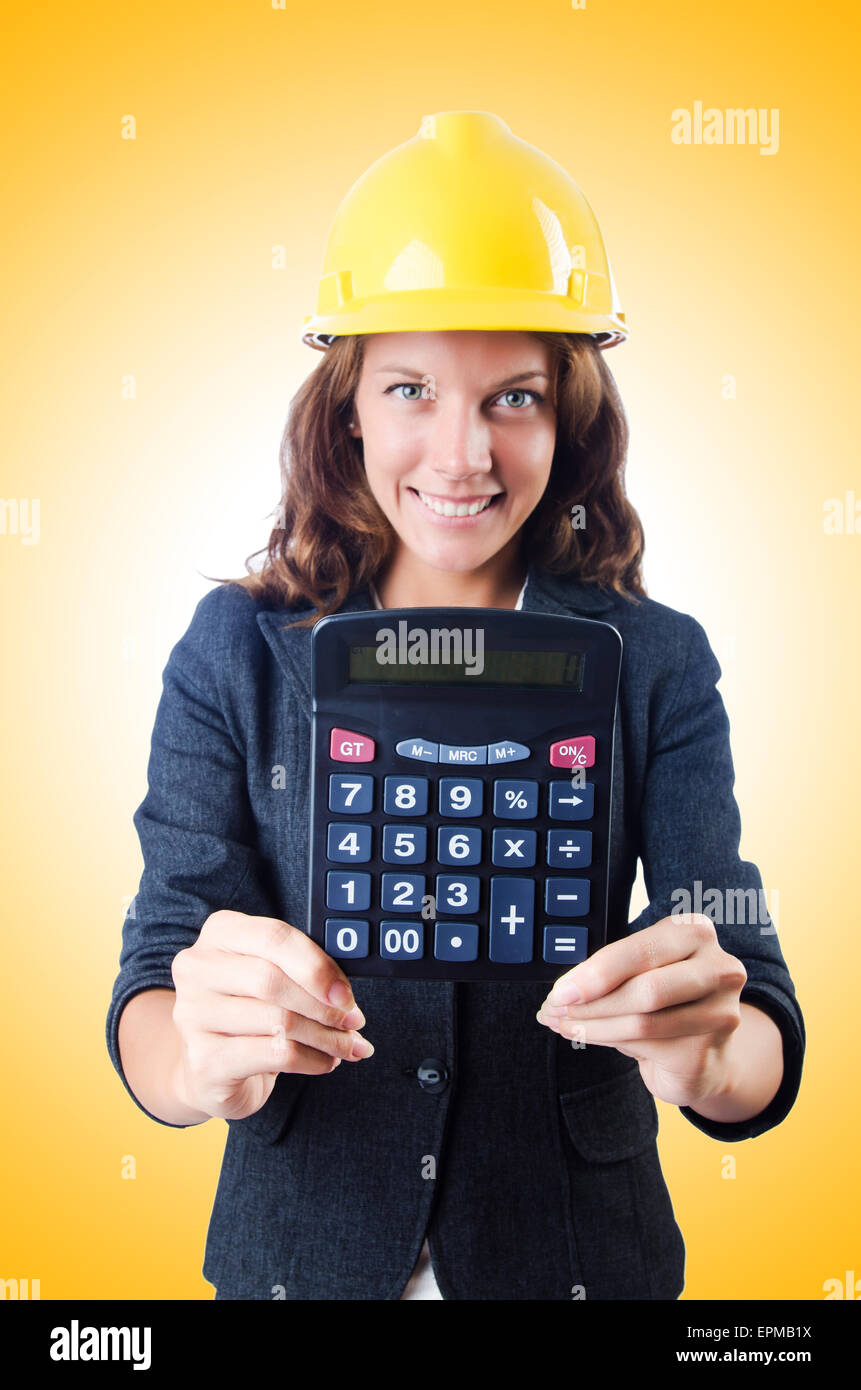 Female builder with calculator on white Stock Photo - Alamy