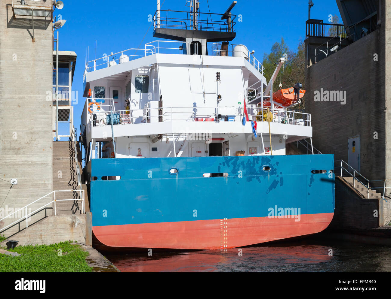Big cargo ship comes to the narrow gateway of Tsvetochnoye lock on the ...