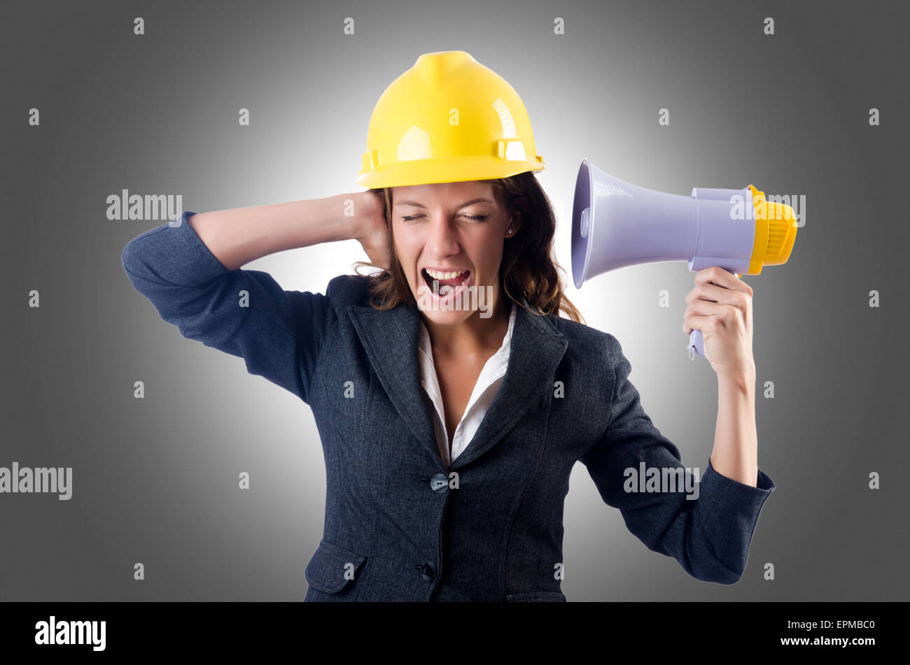 Female construction worker with loudspeaker Stock Photo - Alamy