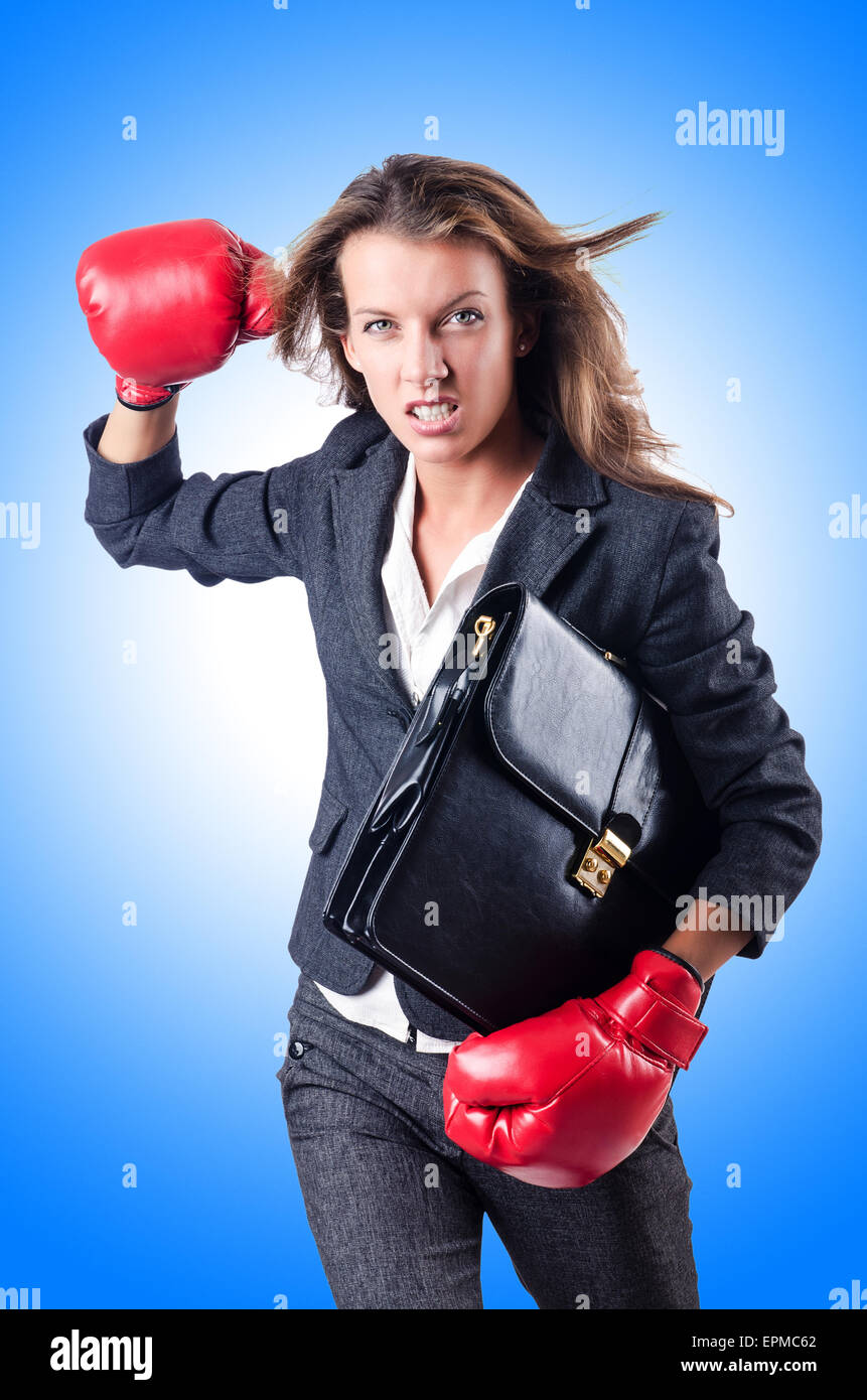Angry businesswoman with boxing gloves Stock Photo - Alamy