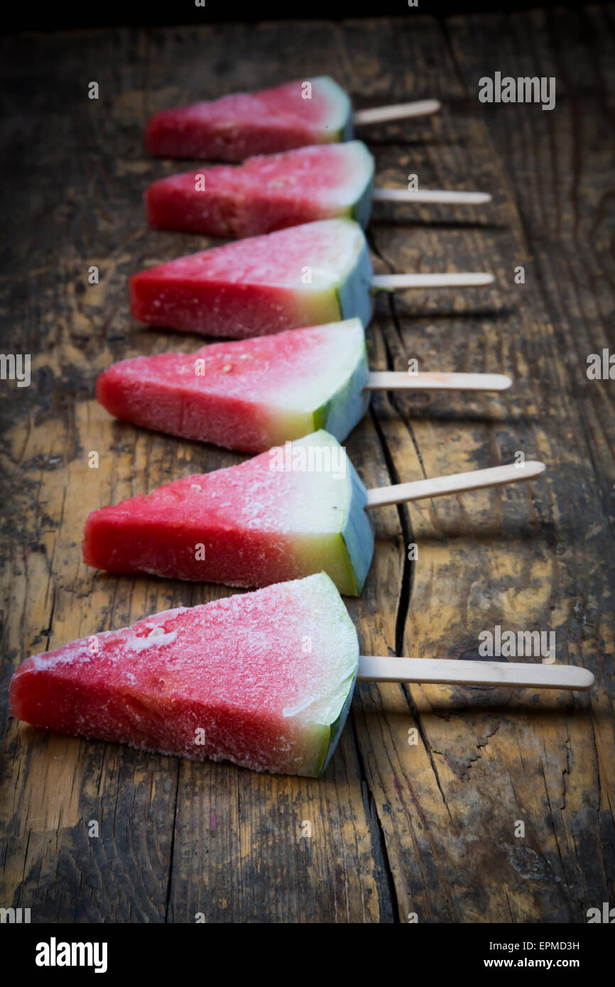 Row of six watermelon popsicles Stock Photo - Alamy