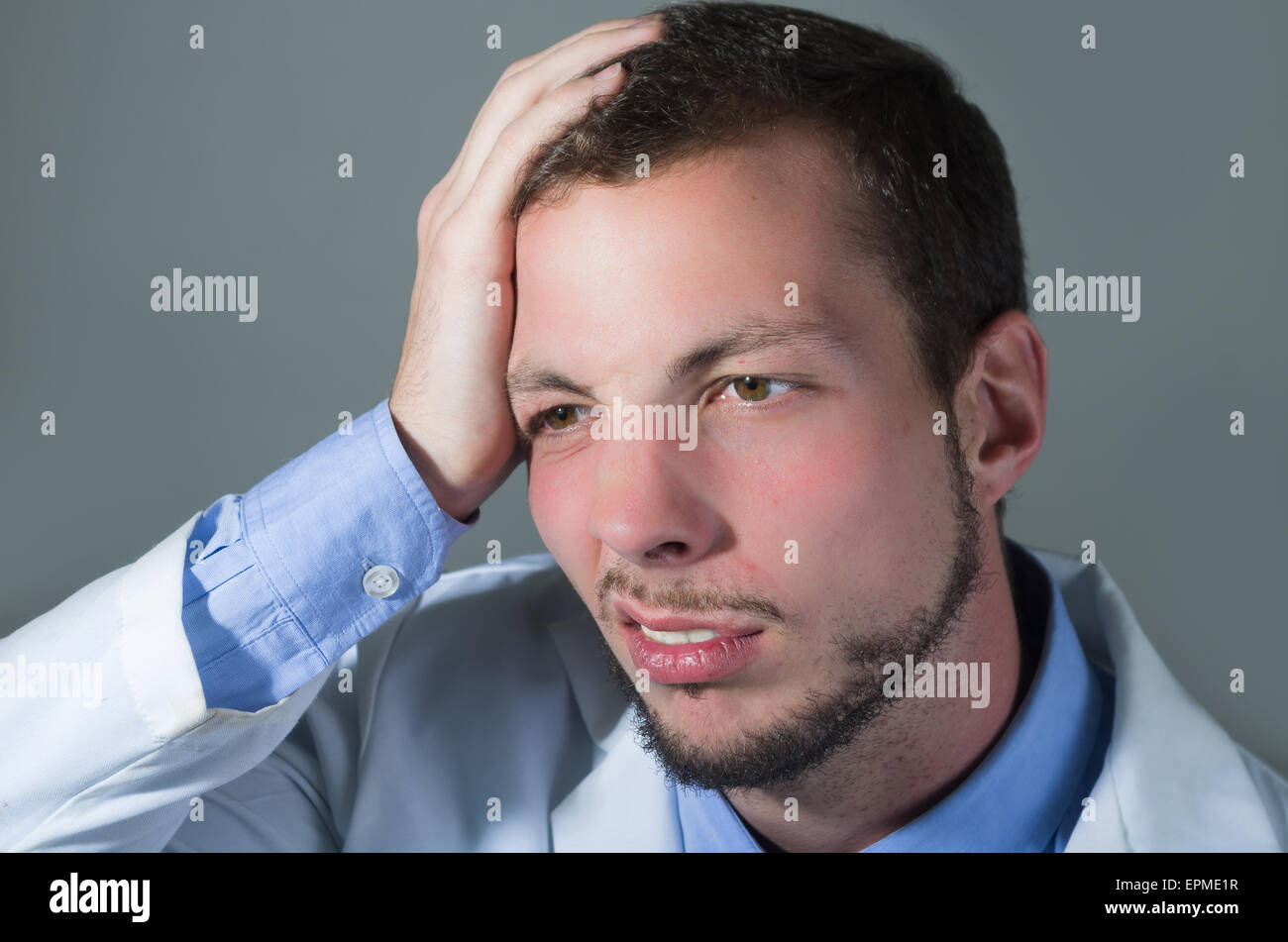 Closeup portrait of handsome young confused doctor Stock Photo - Alamy