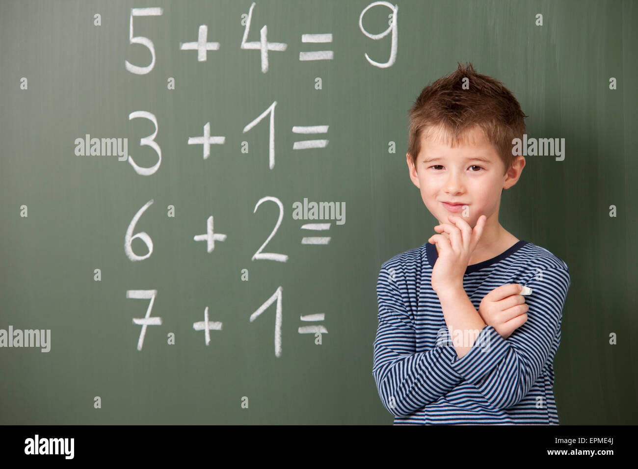 Schoolboy at blackboard with arithmetic problems Stock Photo - Alamy