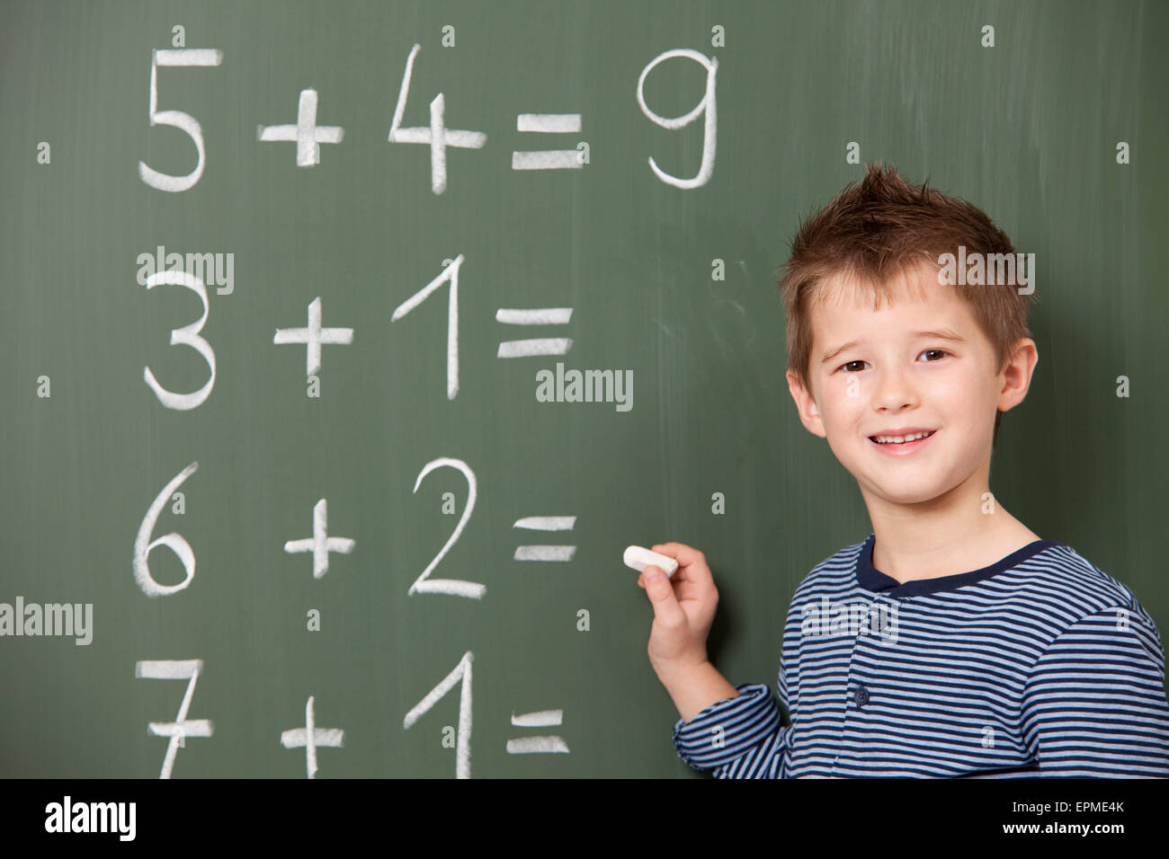 Schoolboy at blackboard with arithmetic problems Stock Photo - Alamy