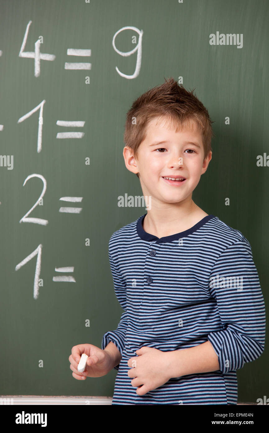 Schoolboy at blackboard with arithmetic problems Stock Photo - Alamy