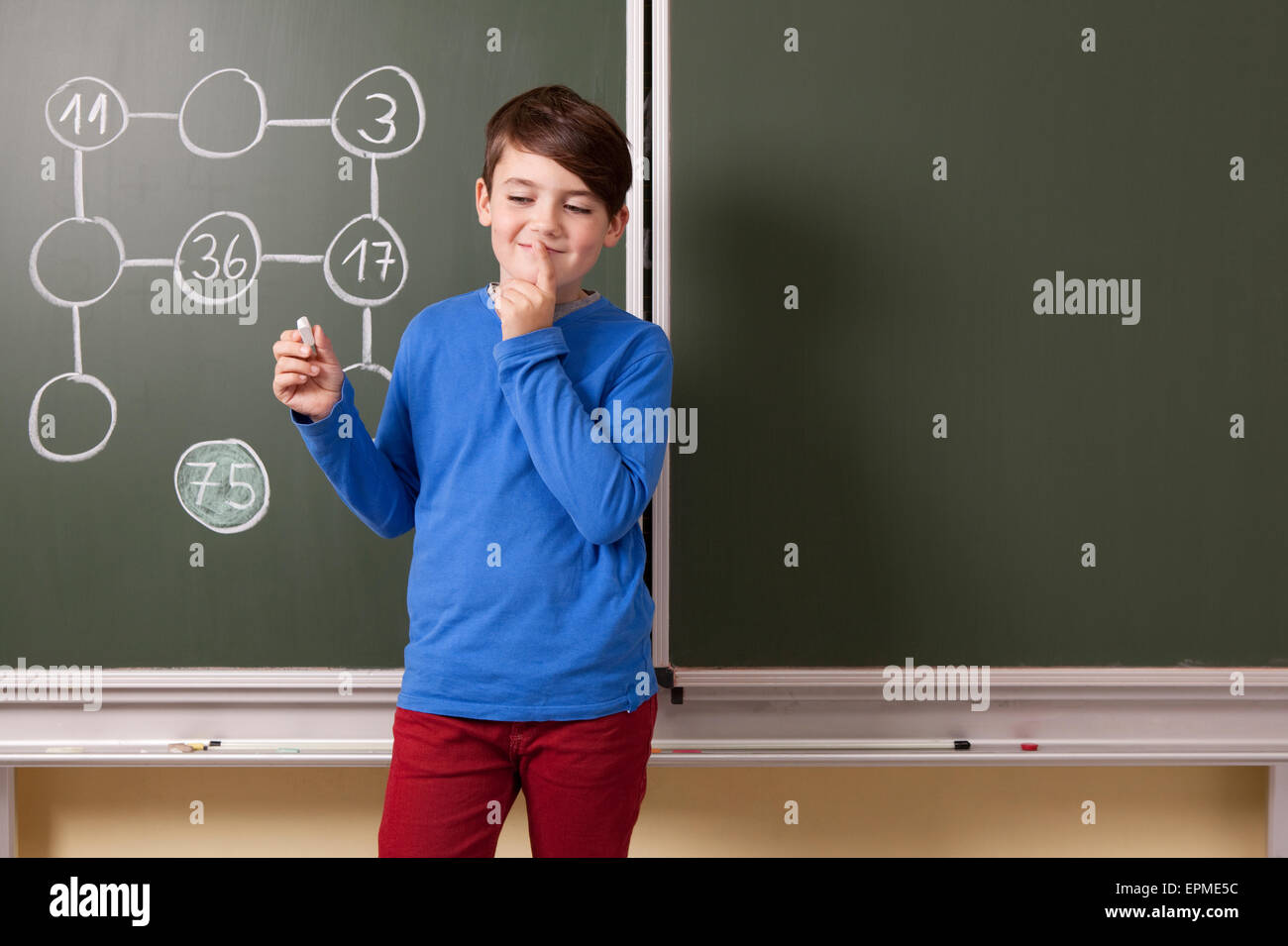 Schoolboy at blackboard with arithmetic problem Stock Photo - Alamy