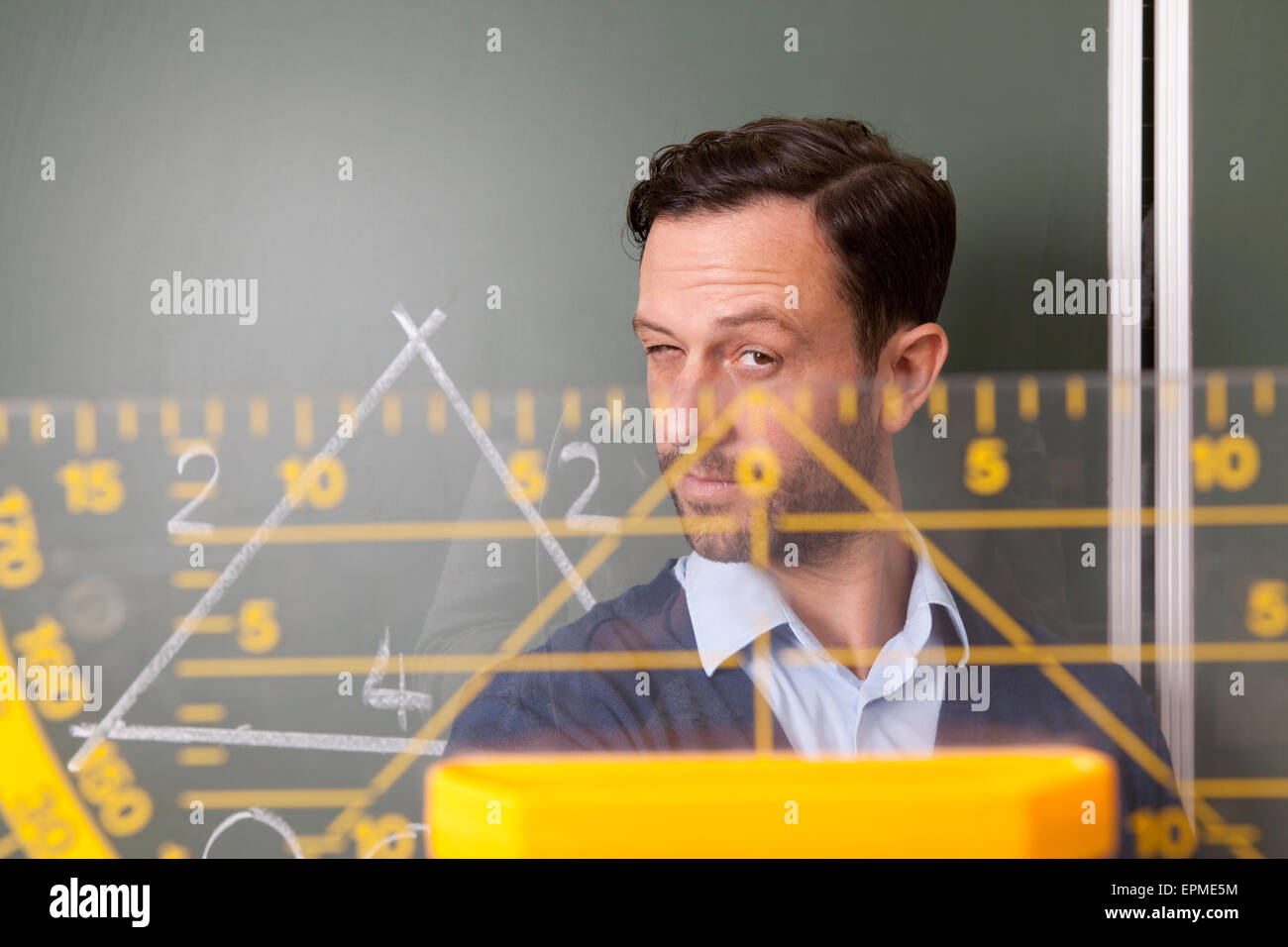 Teacher in classroom teaching geometry Stock Photo - Alamy