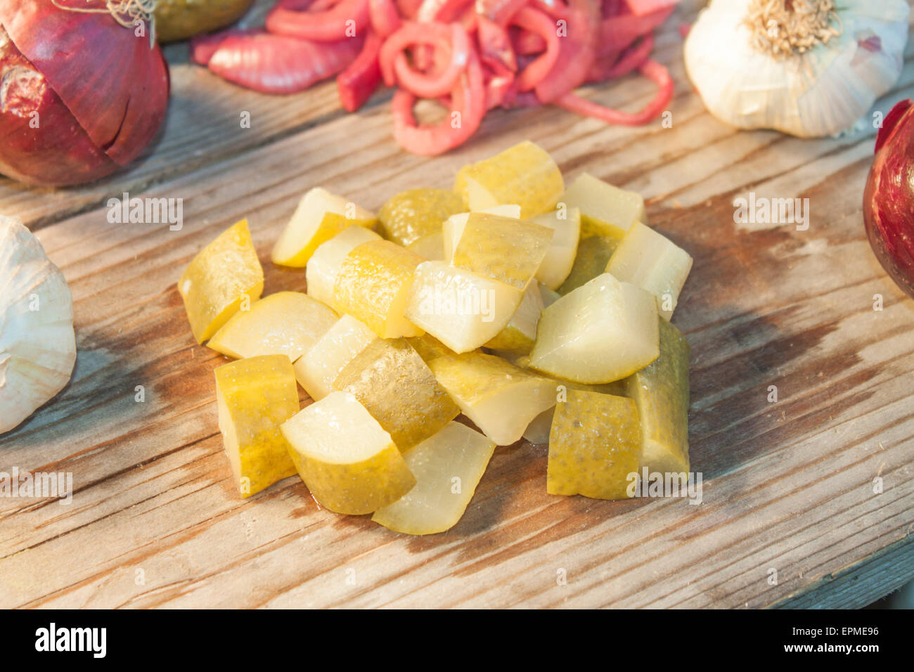 A pile of pickled cucumber dice, in front of garlic and red onion Stock ...