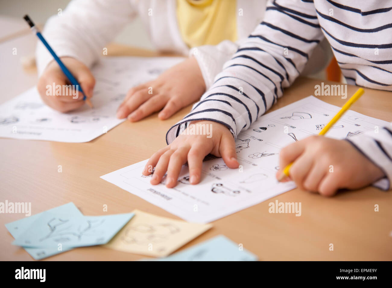 Schoolgirls working on work sheets in classroom Stock Photo - Alamy