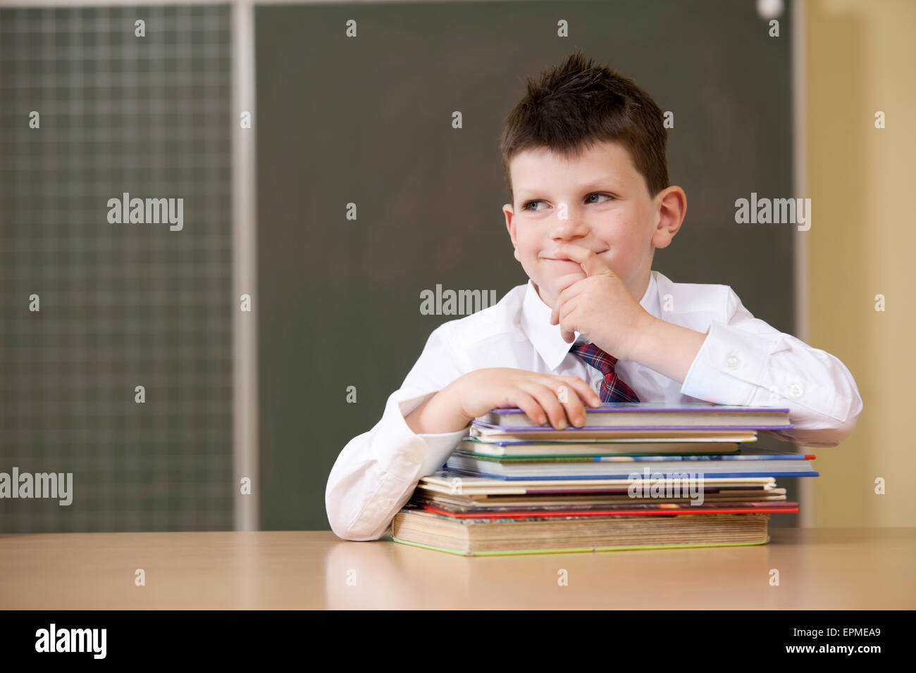 Portrait of thinking schoolboy in classroom Stock Photo - Alamy