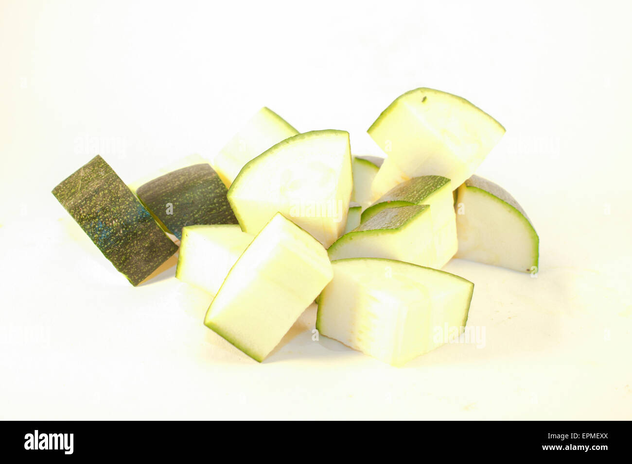 A pile of zucchini cubes, isolated on white background Stock Photo - Alamy