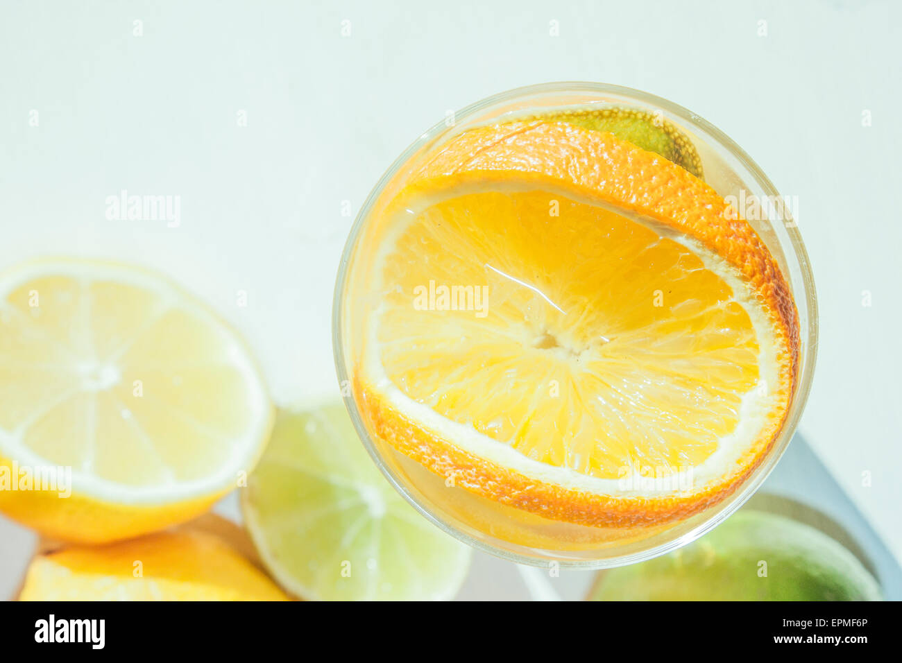 Orange slice inside a glass, near lemons, limes and oranges Stock Photo ...