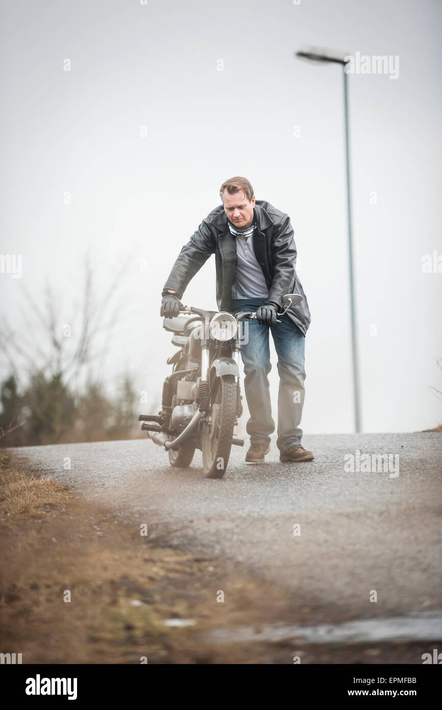 Pushing moped hi-res stock photography and images - Alamy