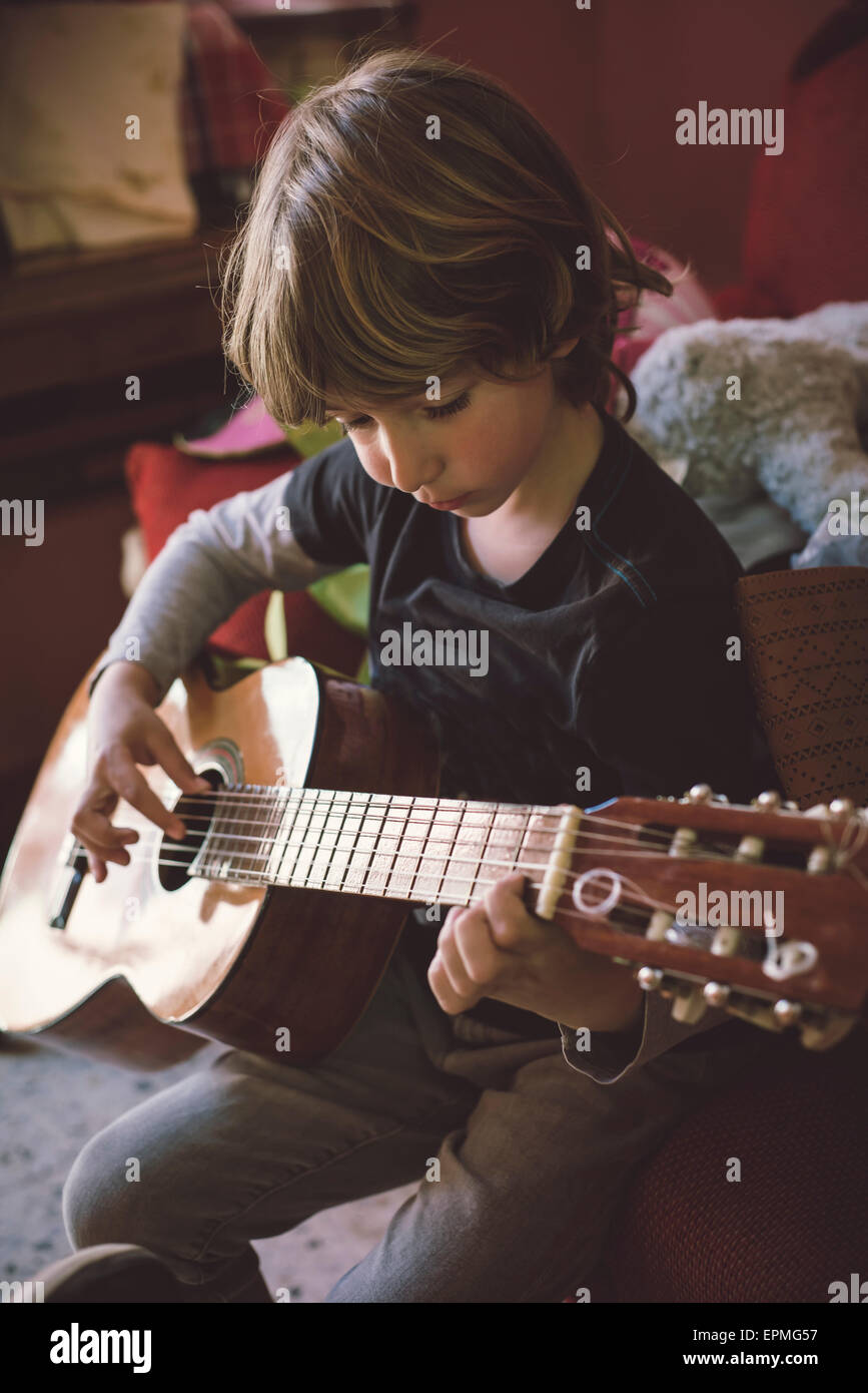 Little boy playing acoustic guitar at home Stock Photo - Alamy