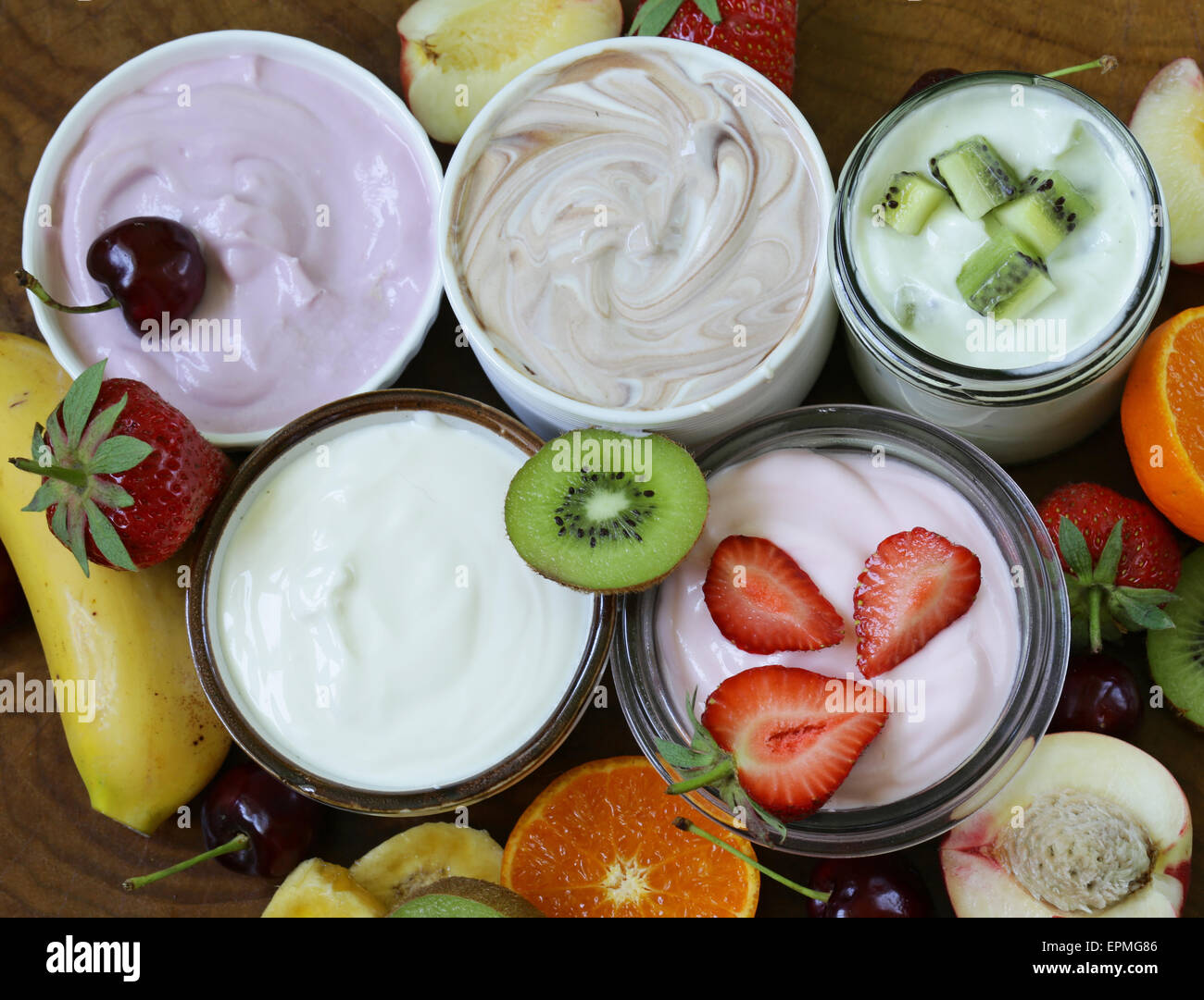 assortment of different yogurt for breakfast with berries and fruits ...