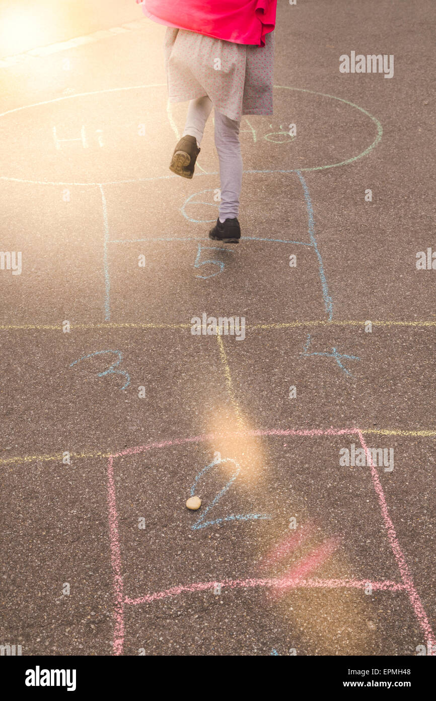Little girl playing hopscotch Stock Photo - Alamy