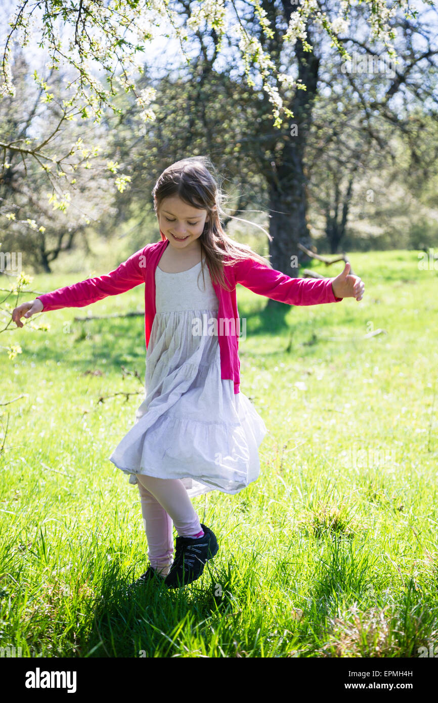 Girl dancing on a meadow in springtime Stock Photo - Alamy