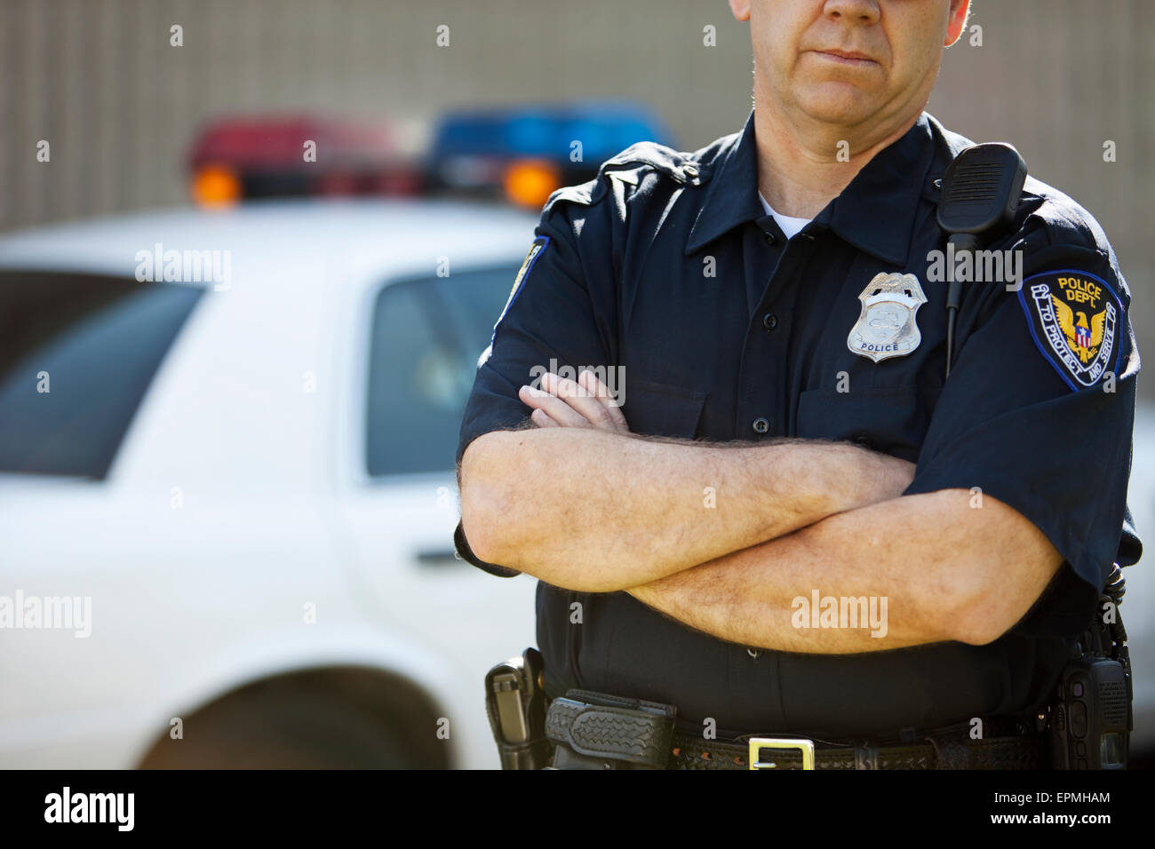 USA, serious cop standing by car Stock Photo - Alamy