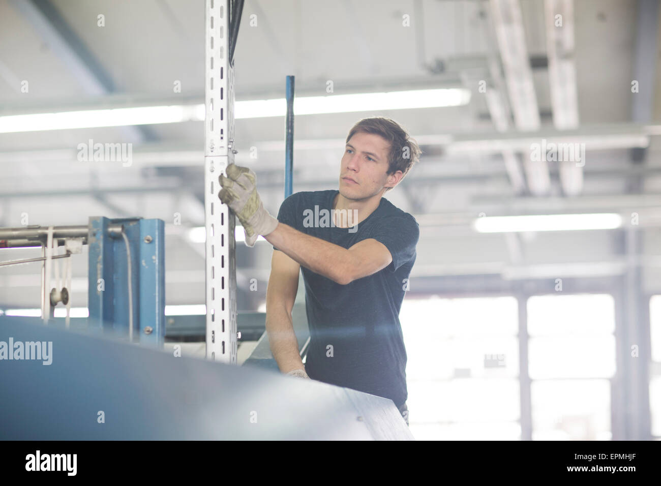 Technician in factory controlling machine Stock Photo - Alamy