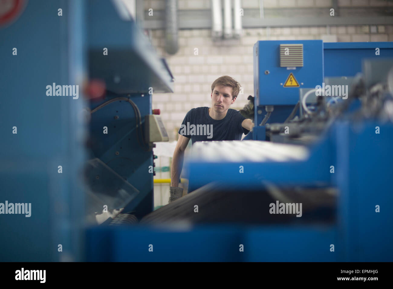Technician in factory controlling machine Stock Photo - Alamy