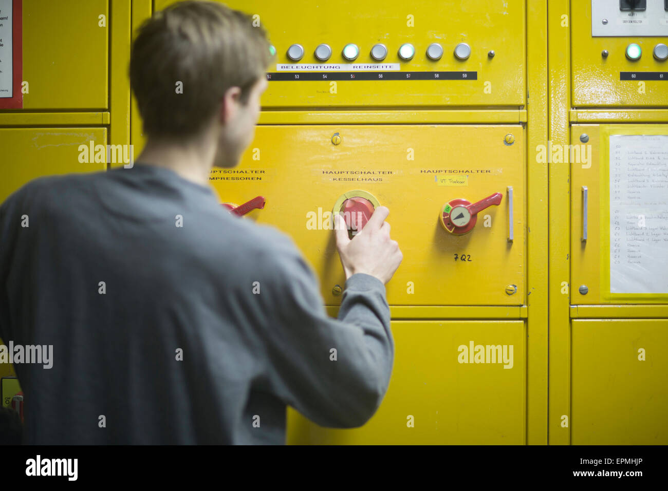 Technician adjusting control lever of machine Stock Photo - Alamy
