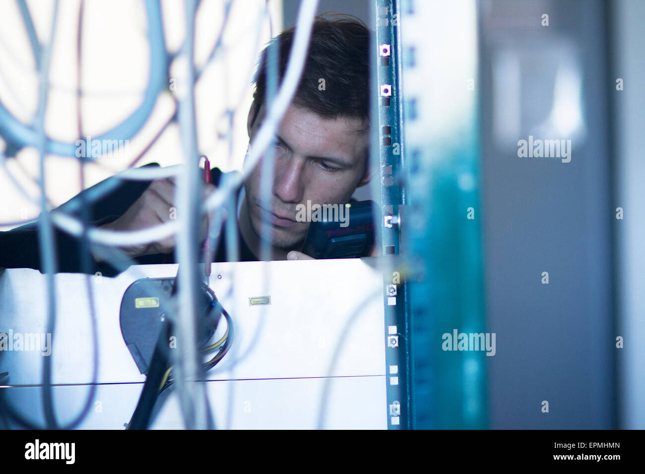 Technician checking installation with measuring device Stock Photo - Alamy