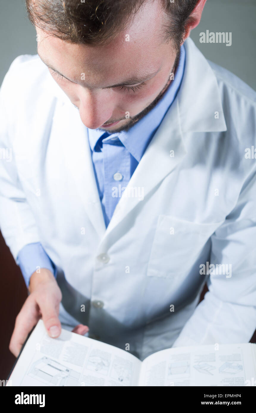 Closeup portrait of handsome young doctor reading Stock Photo - Alamy