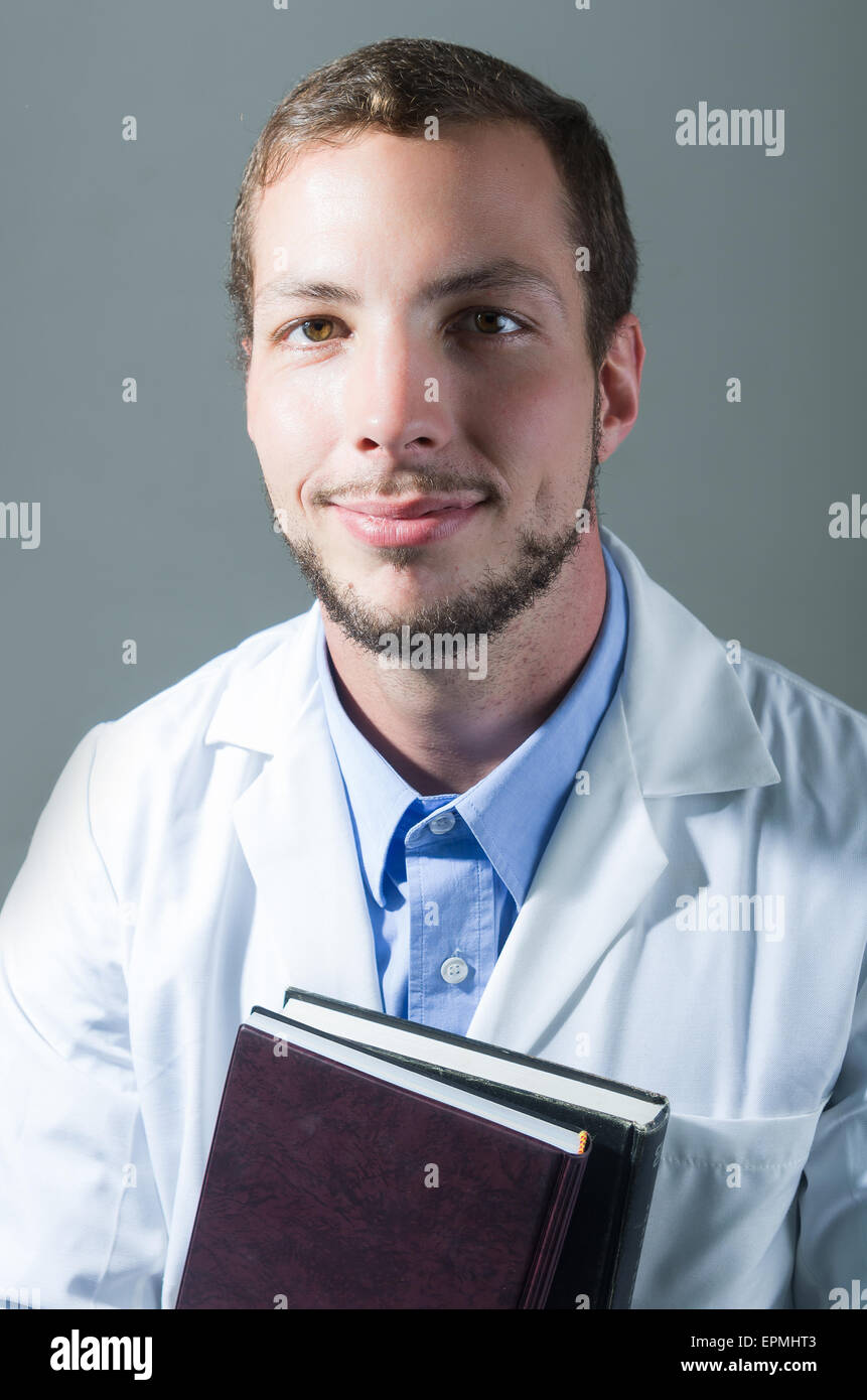 Closeup portrait of handsome young doctor holding books Stock Photo - Alamy