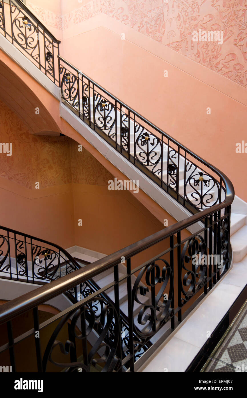 Staircase with iron railing and pink walls in a hotel in Barcelona ...