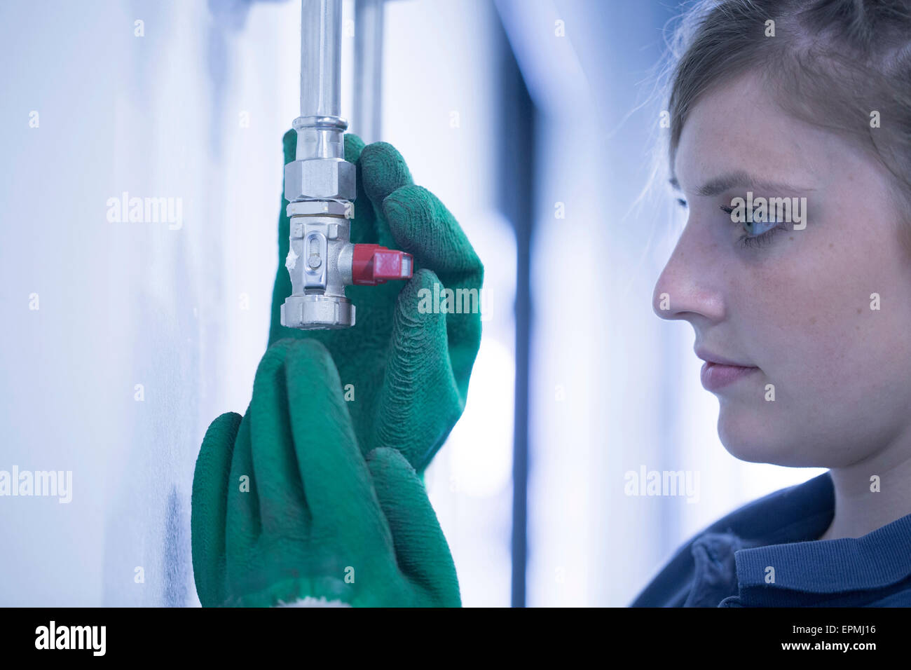 Technician adjusting lever Stock Photo - Alamy