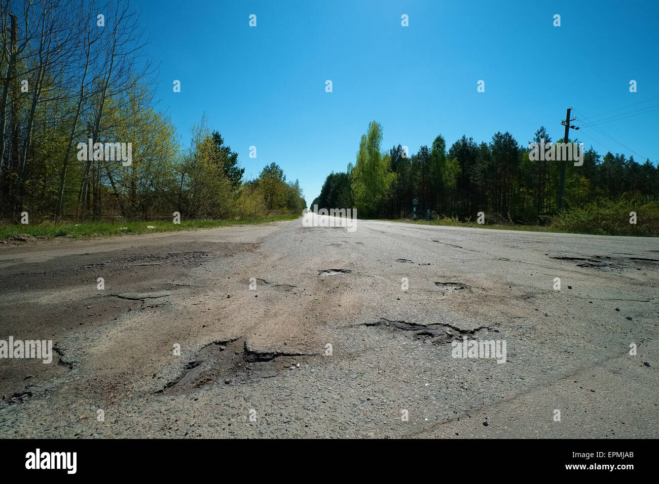 Road with potholes Stock Photo - Alamy